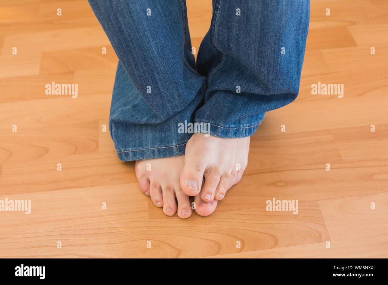 Mens feet on wooden floor at home Stock Photo - Alamy