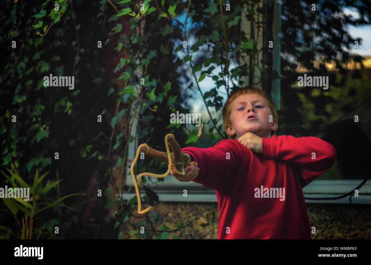 Boy aiming with slingshot hi-res stock photography and images - Alamy