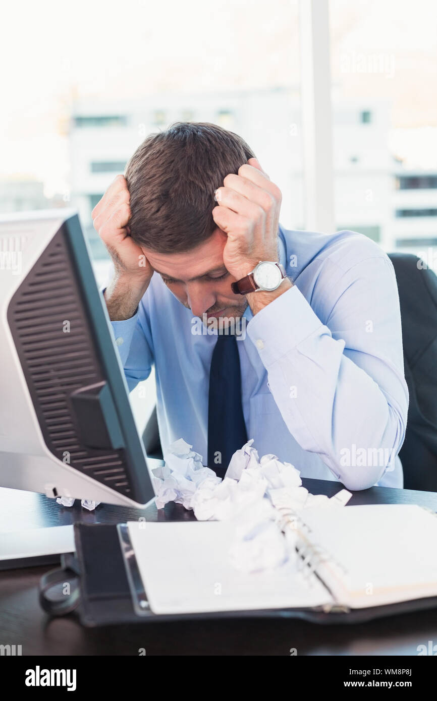 Desperate businessman at his desk in his office Stock Photo - Alamy