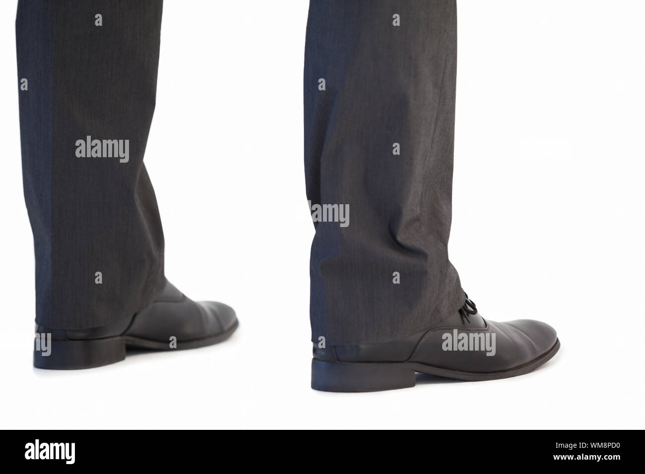 Close up of legs of a businessman on white background Stock Photo - Alamy