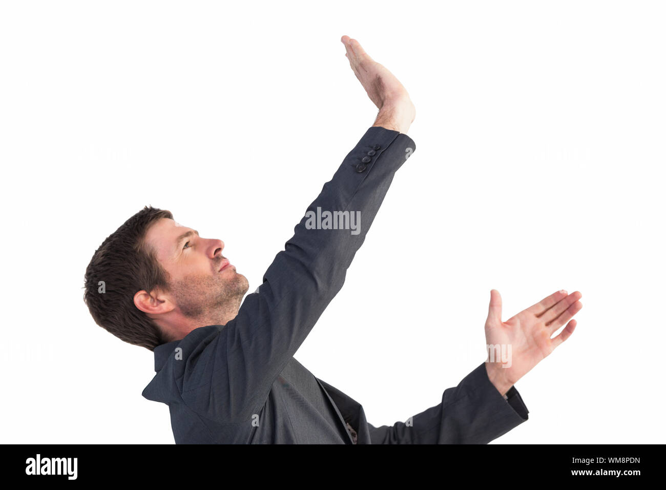 Businessman in suit pushing with hands on white background Stock Photo ...
