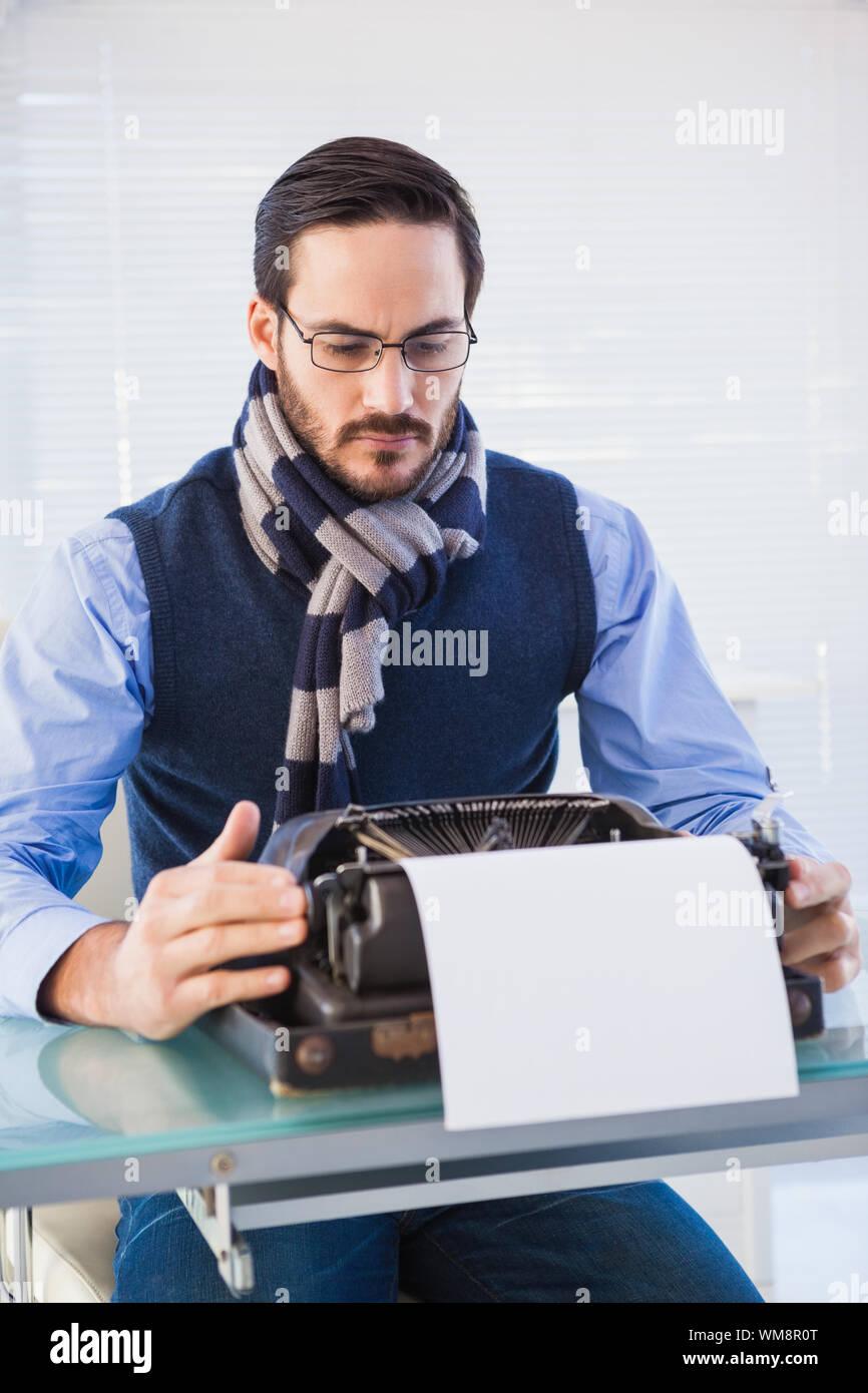 Serious businessman working on typewriter in the office Stock Photo - Alamy