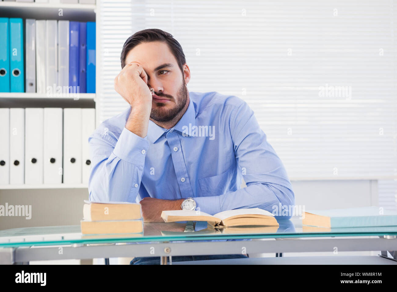 Casual bored businessman at his desk in the office Stock Photo - Alamy