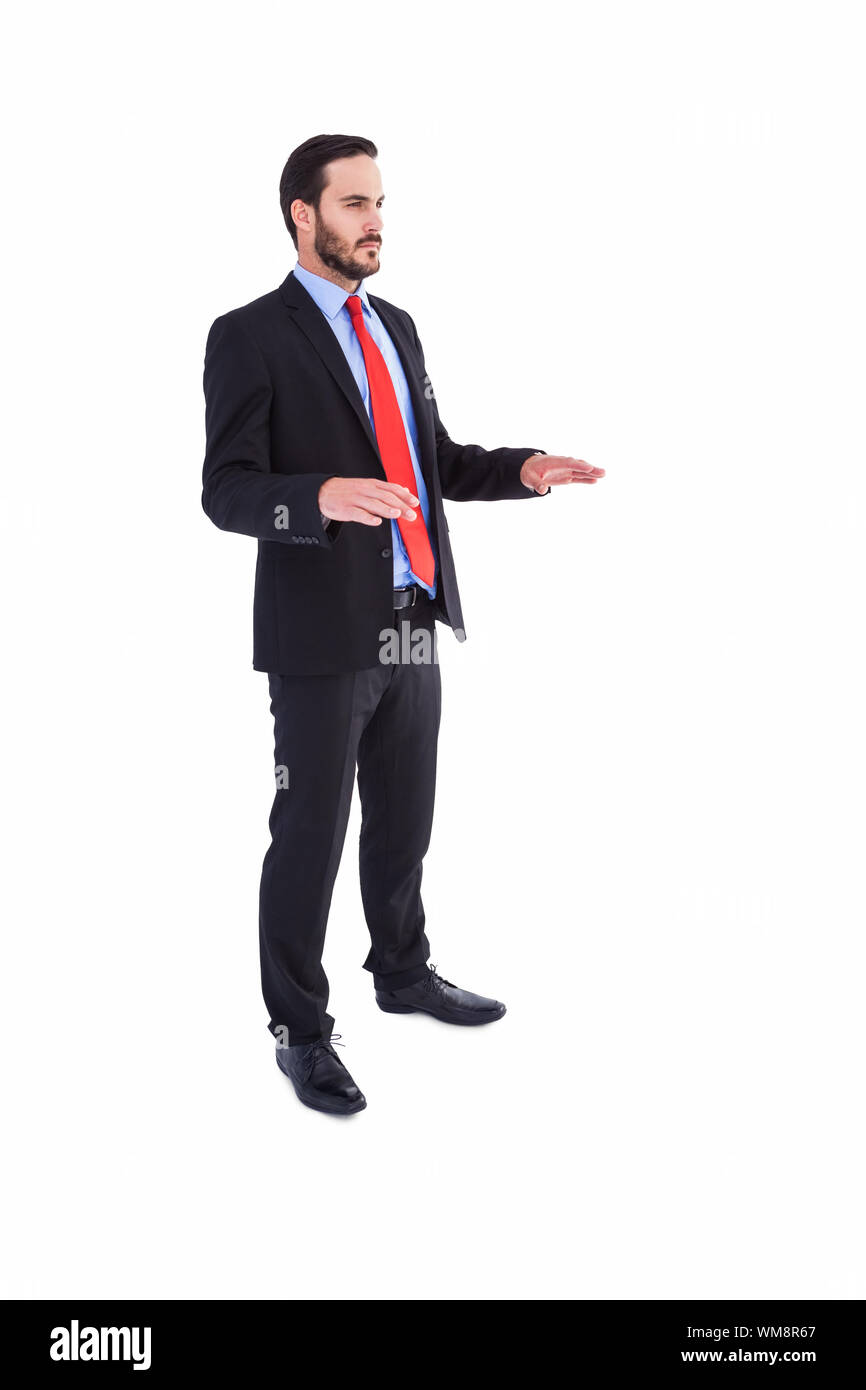 Frowning businessman presenting with hands on white background Stock Photo - Alamy