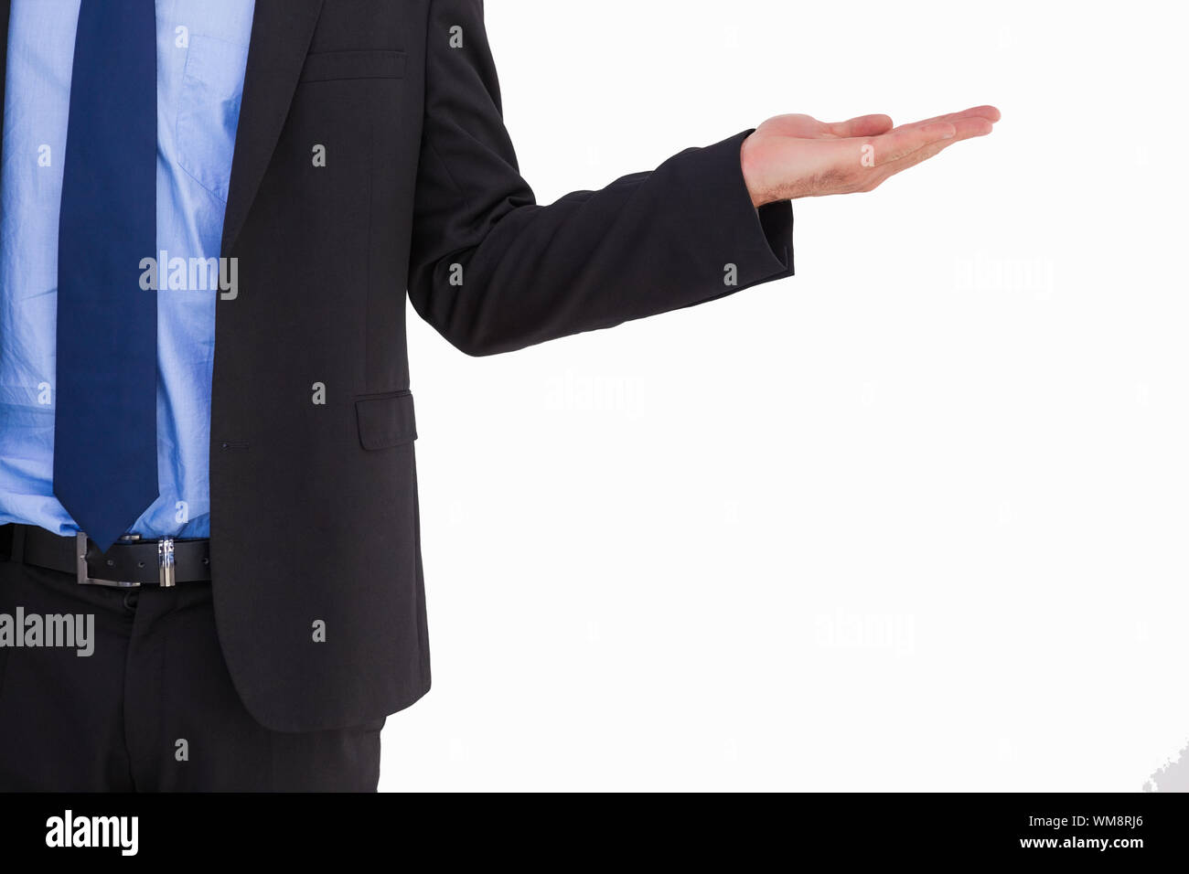 Businessman holding hand out in presentation on white background Stock ...