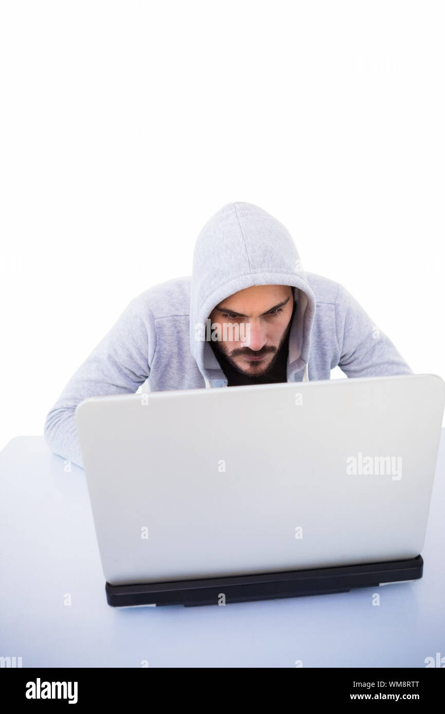 Serious burglar hacking into laptop on white background Stock Photo - Alamy