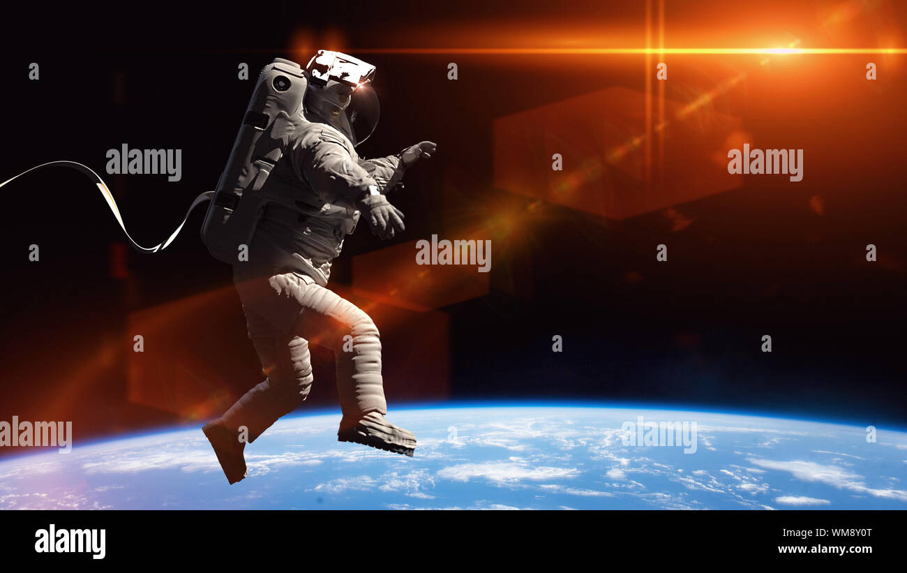 astronaut performing a space walk in orbit of the blue planet Earth ...