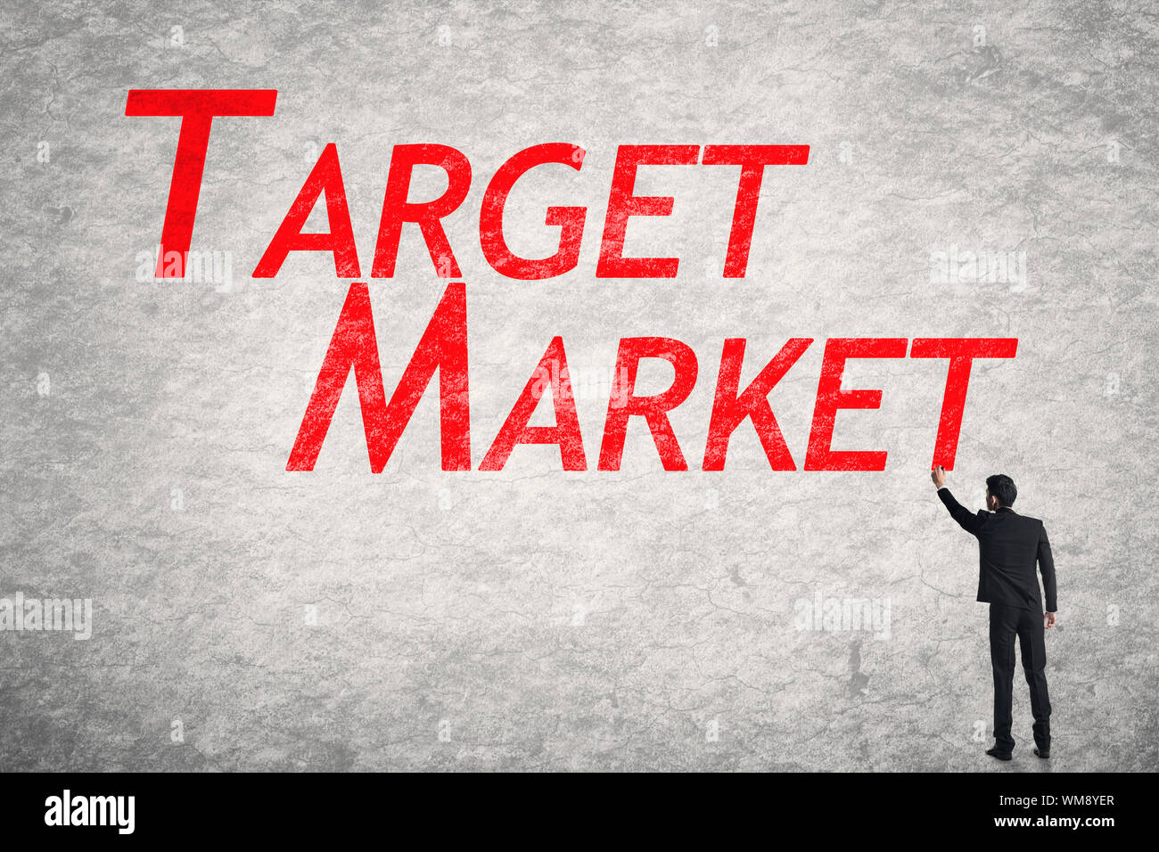 Asian business man write words on wall, Target Market Stock Photo - Alamy