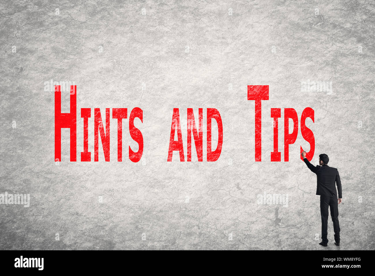 Asian business man write words on wall, Hints and Tips Stock Photo - Alamy