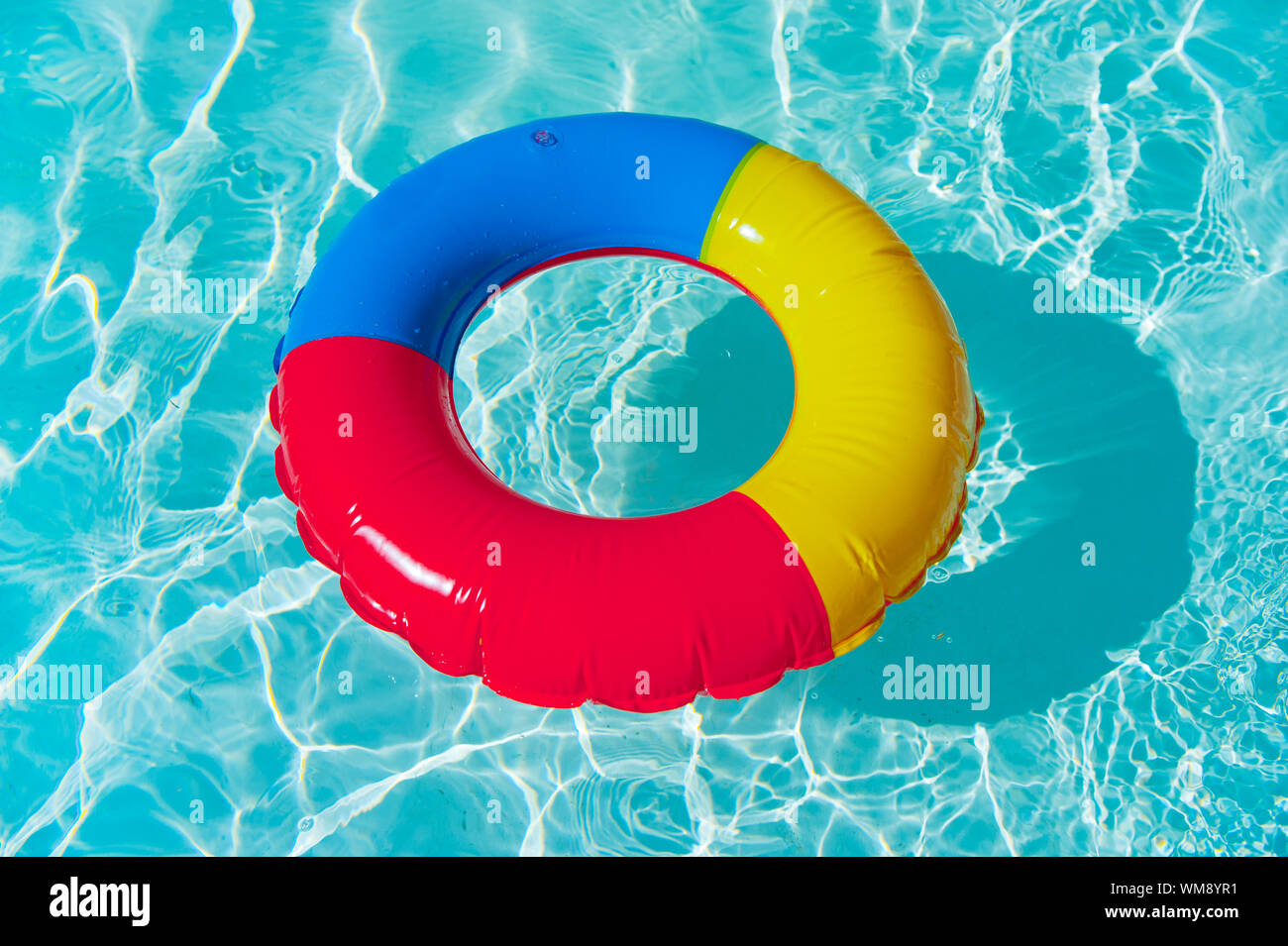 Colorful toy swimming tire at the pool Stock Photo - Alamy