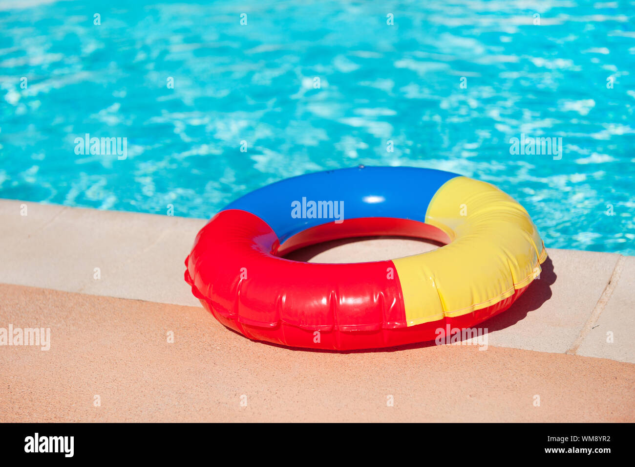 Colorful toy swimming tire at the pool Stock Photo - Alamy