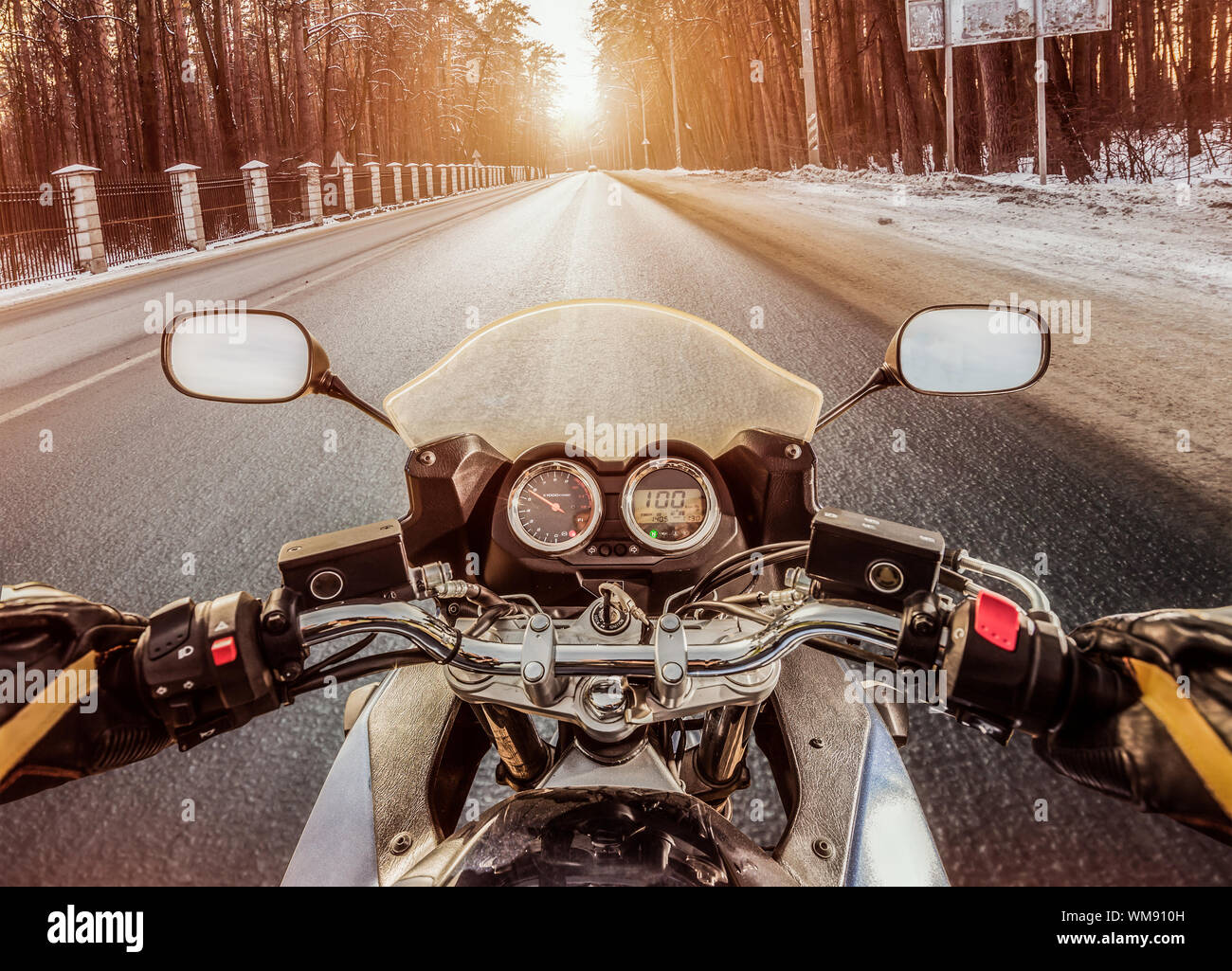 Biker rides on winter slippery road. First-person view Stock Photo - Alamy