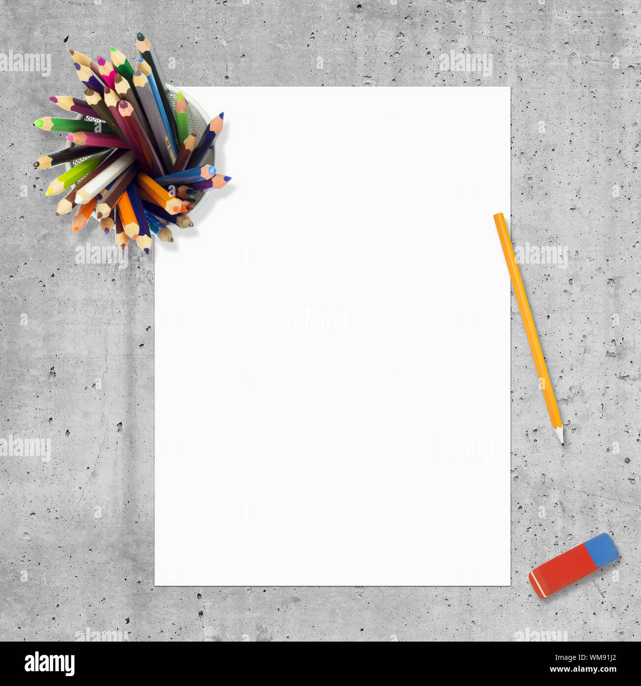 Blank paper with pencils and erasure, on smooth stone surface, top view ...