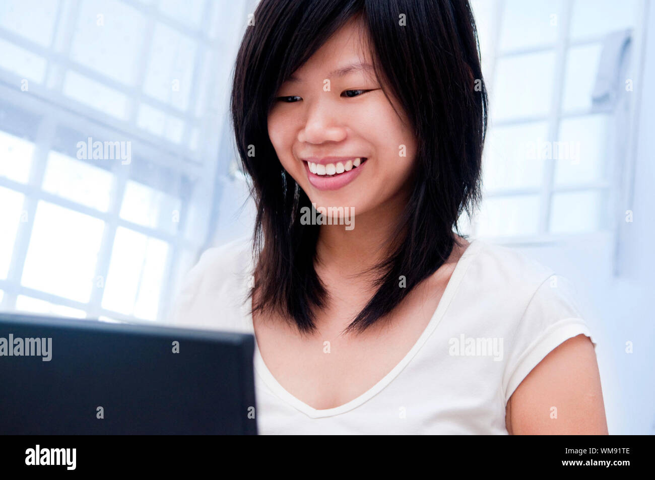 Happy Asian women using internet with smiling face Stock Photo - Alamy