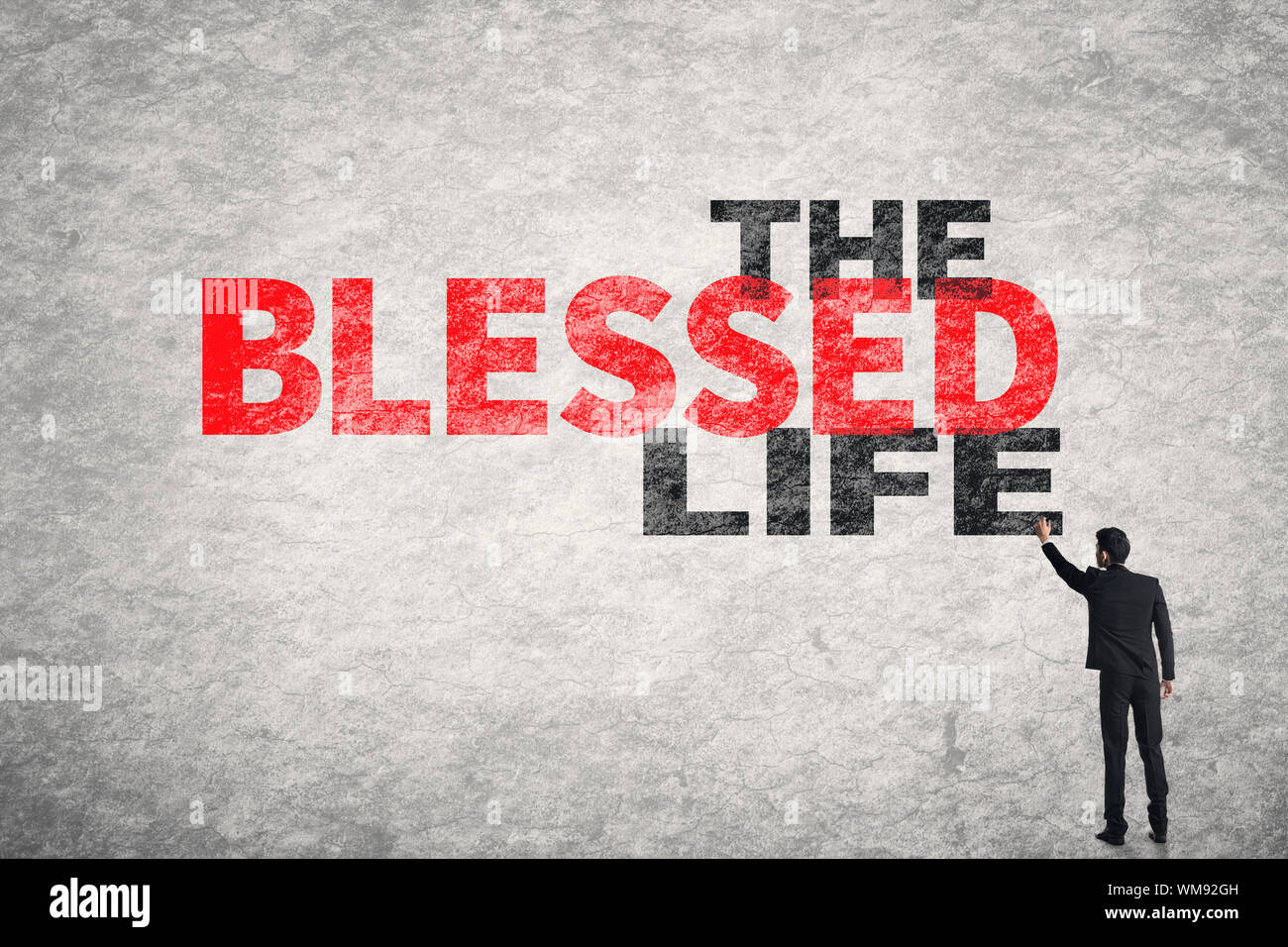 Asian businessman write text on wall, The Blessed Life Stock Photo - Alamy