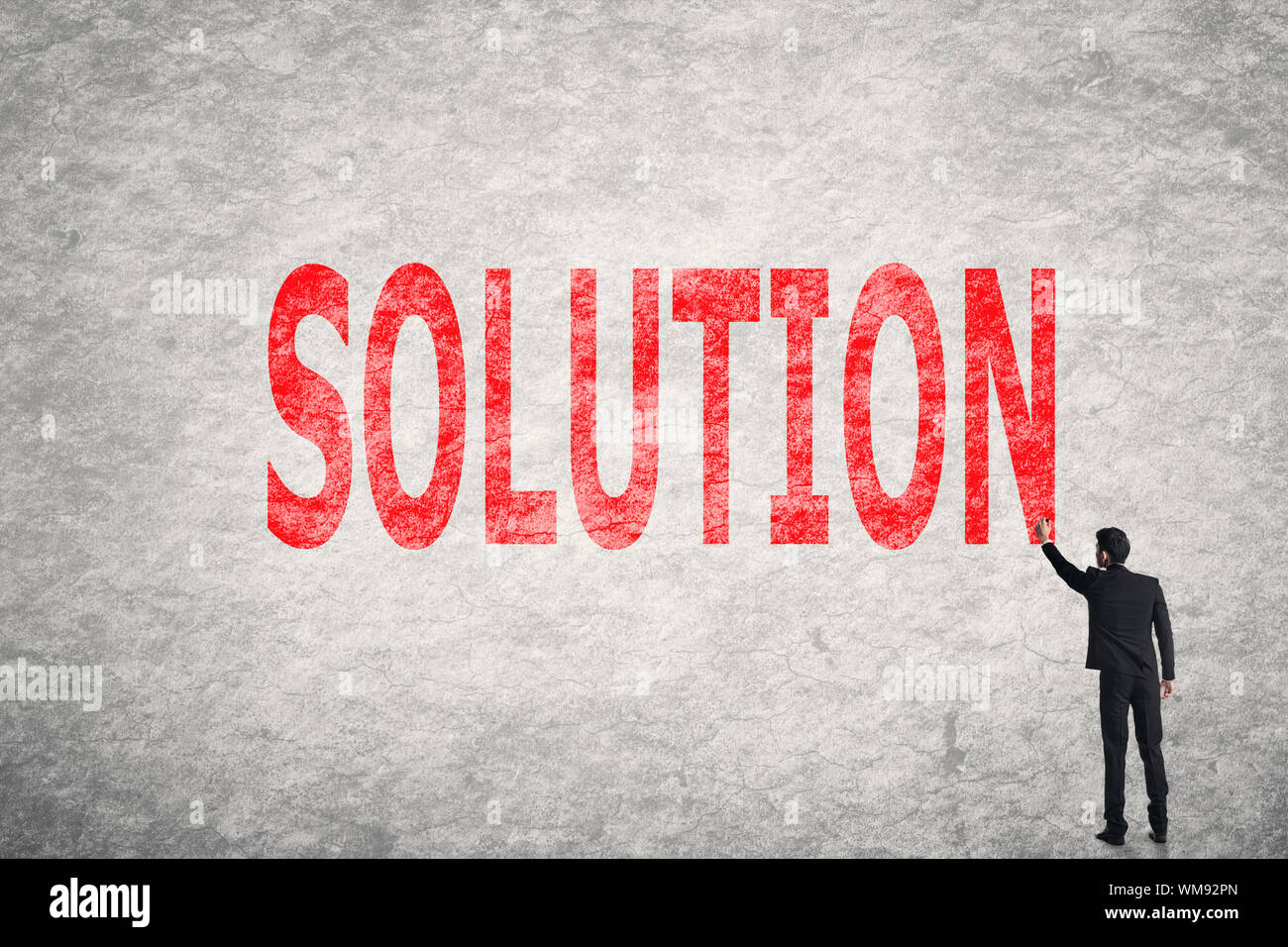 Asian businessman write text on wall, Solution Stock Photo - Alamy