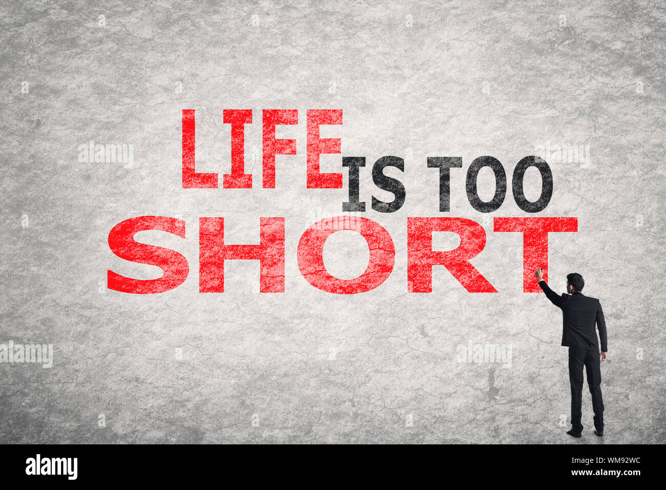 Asian businessman write text on wall, Life is Too Short Stock Photo - Alamy
