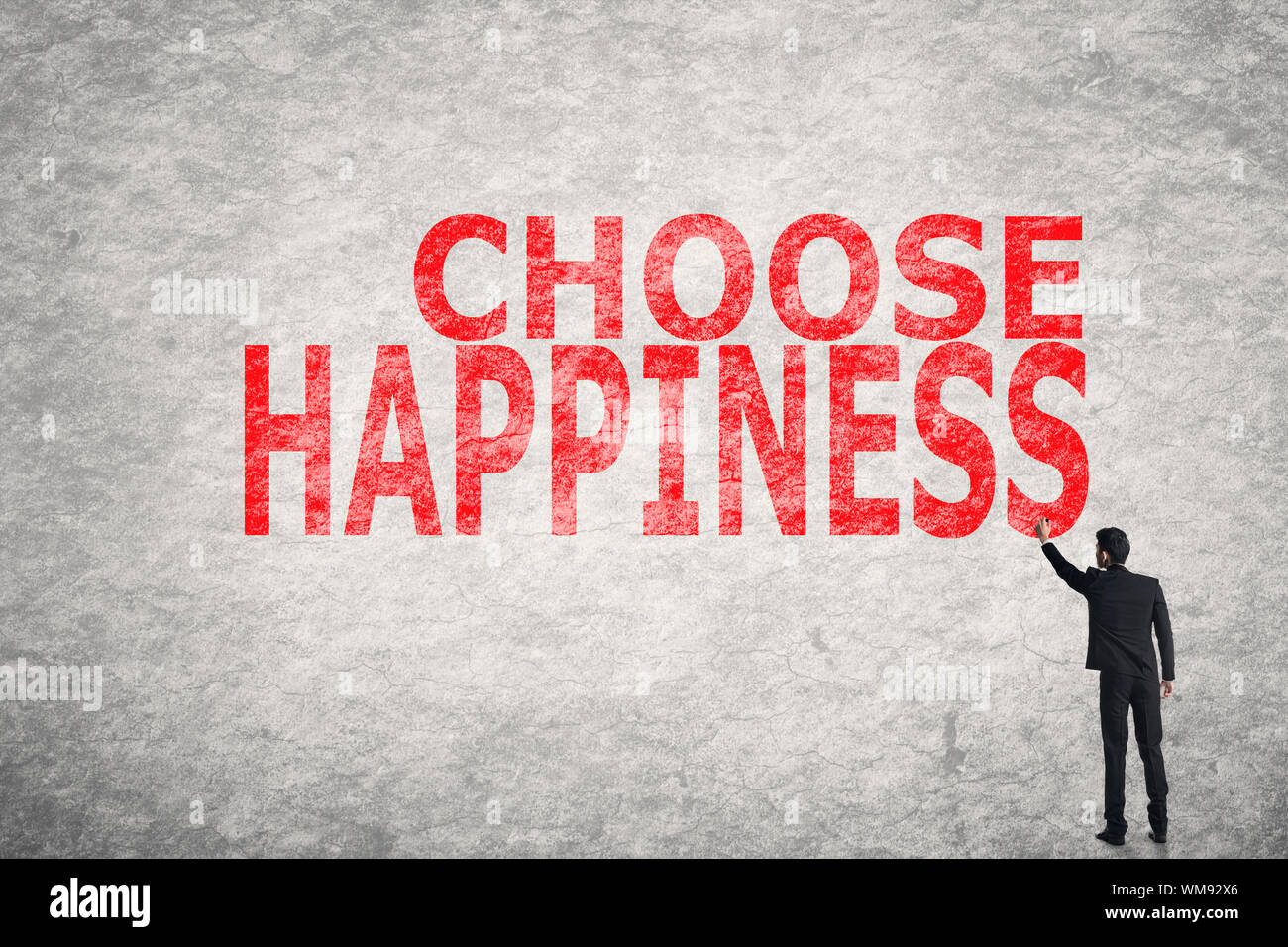 Asian businessman write text on wall, Choose Happiness Stock Photo - Alamy