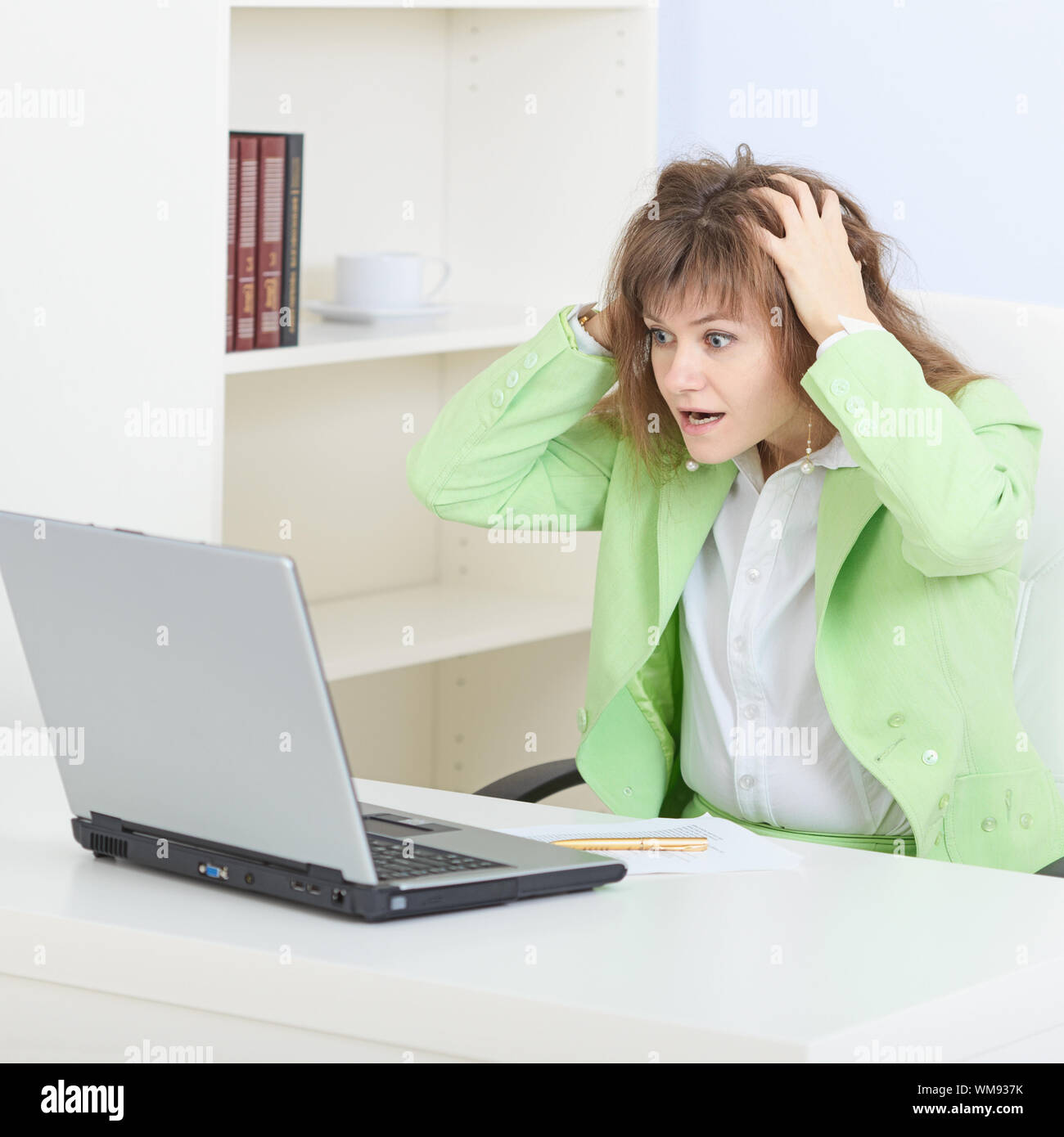 The person in a shock working in the Internet with the laptop Stock ...