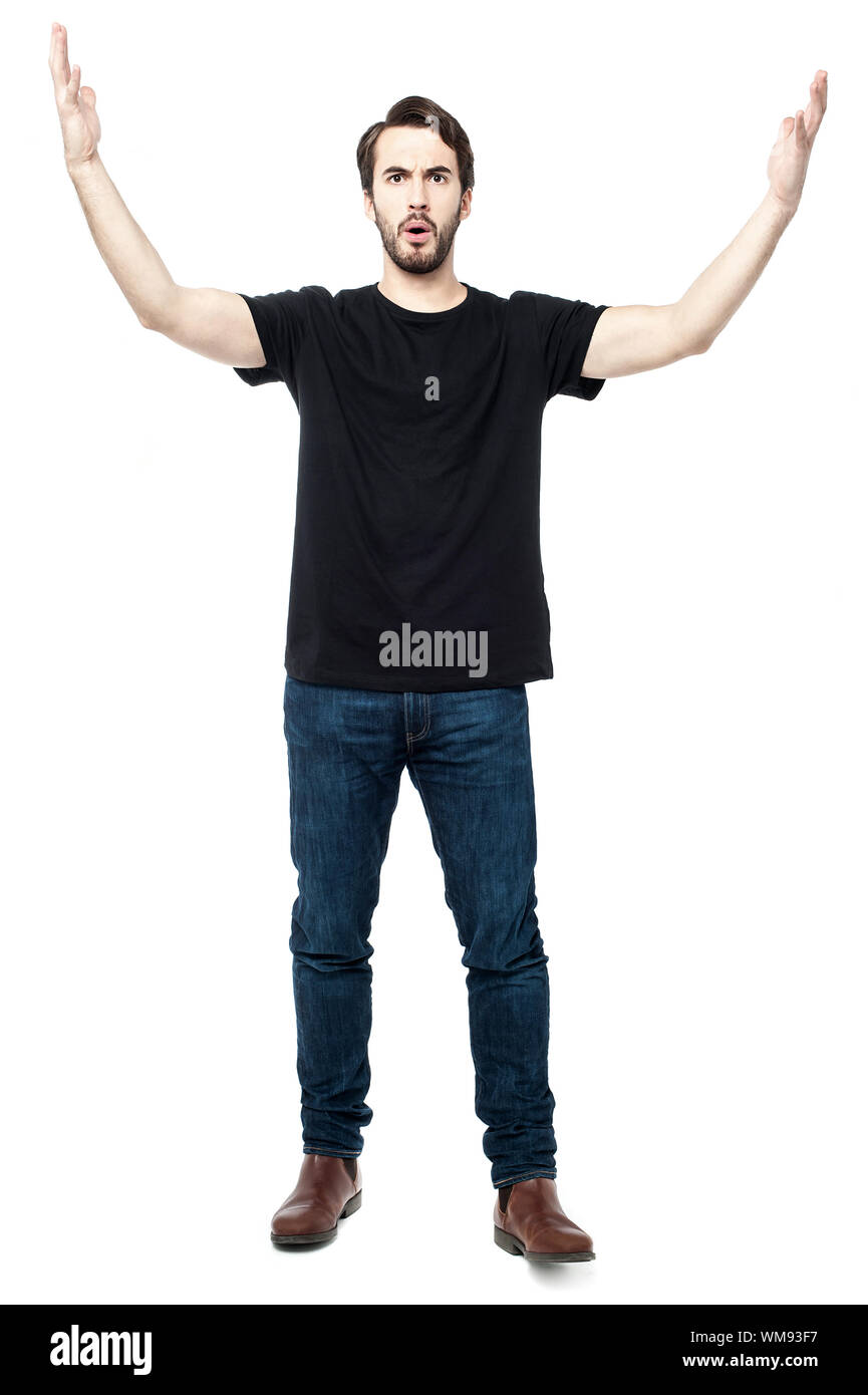 Astonished young man raised his arms Stock Photo - Alamy