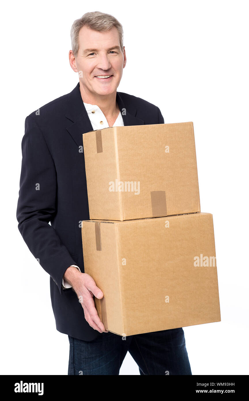 Senior corporate man holding stack of boxes Stock Photo - Alamy