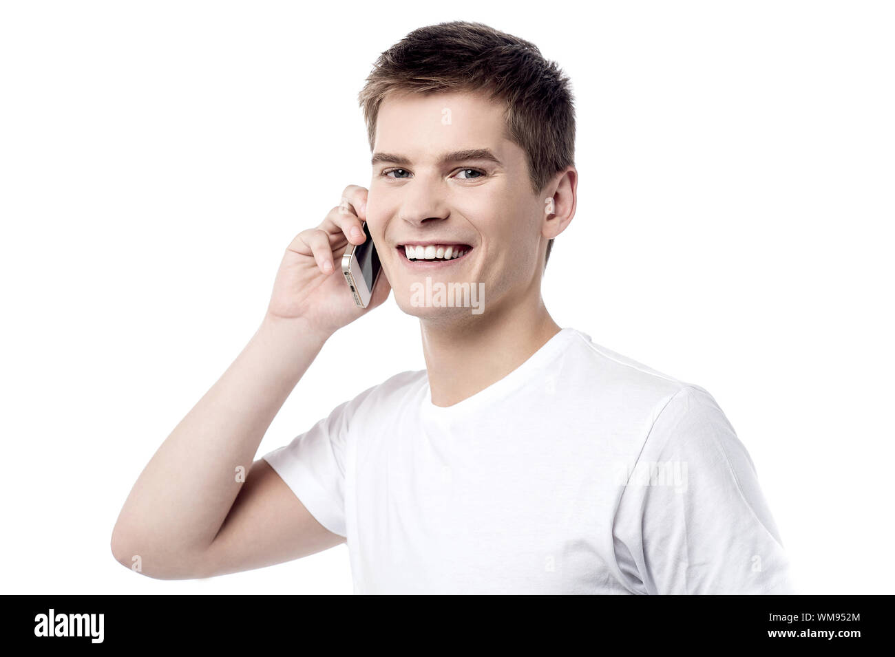 Happy young man posing while talking to someone Stock Photo - Alamy