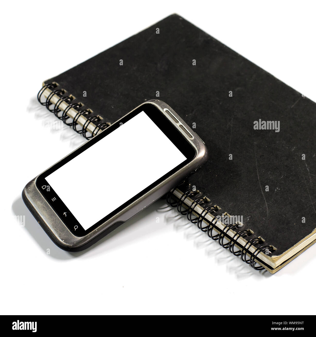smartphone on note book on a white background Stock Photo - Alamy