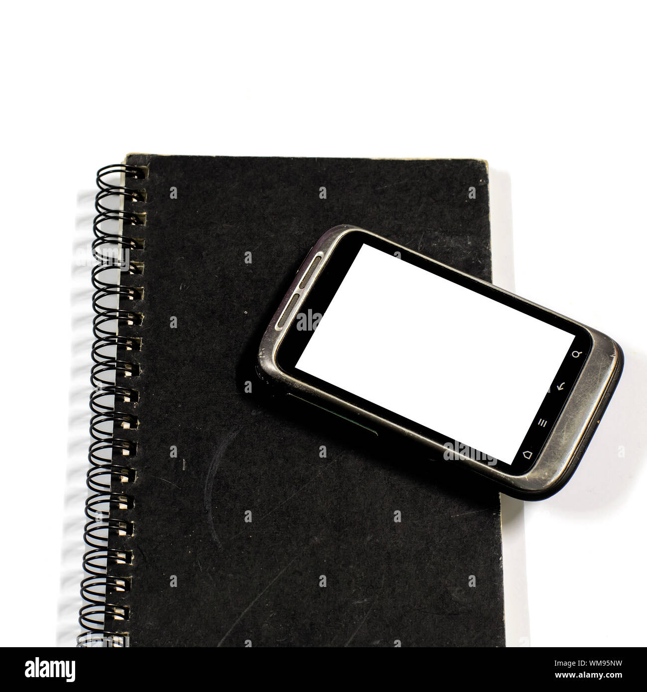 smartphone on note book on a white background Stock Photo - Alamy