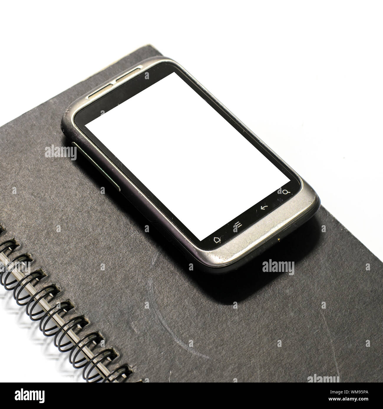 smartphone on note book on a white background Stock Photo - Alamy
