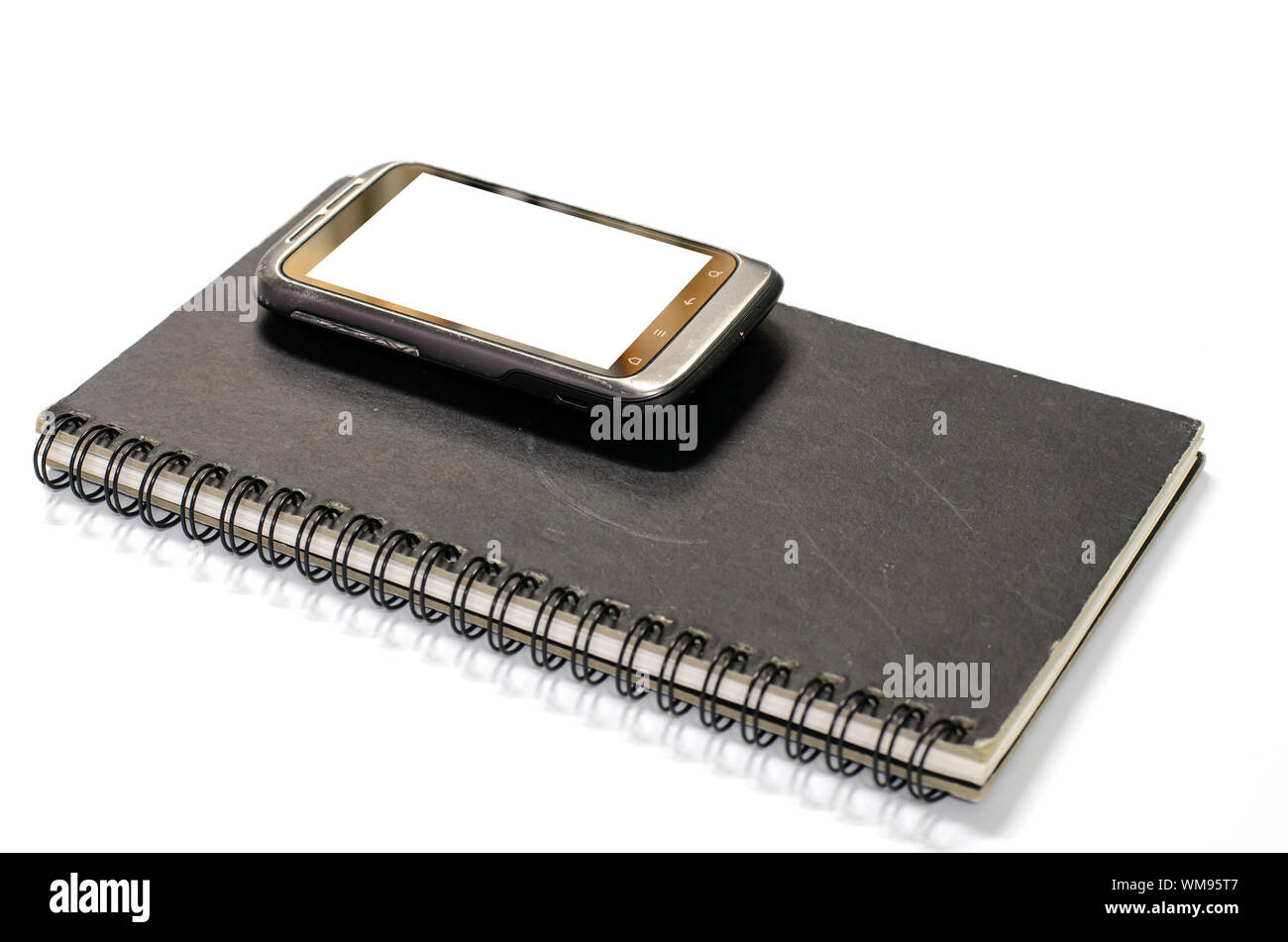 smartphone on note book on a white background Stock Photo - Alamy