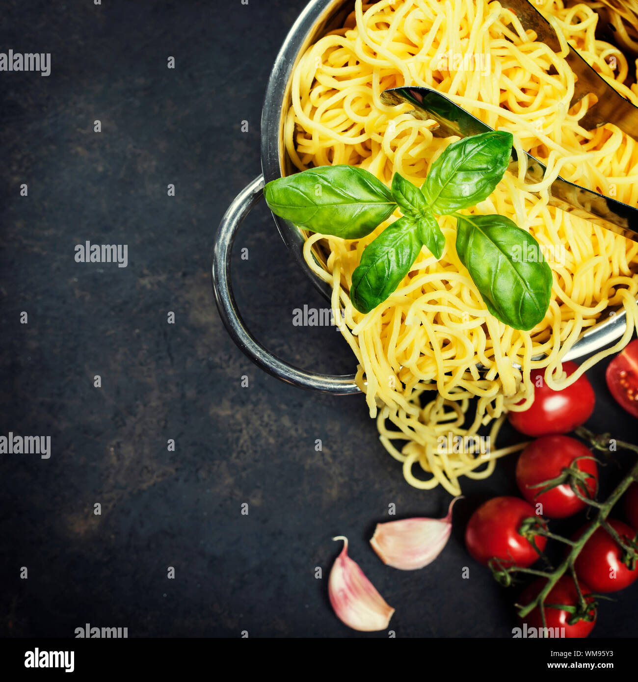 spaghetti in colander on dark vintage background Stock Photo - Alamy