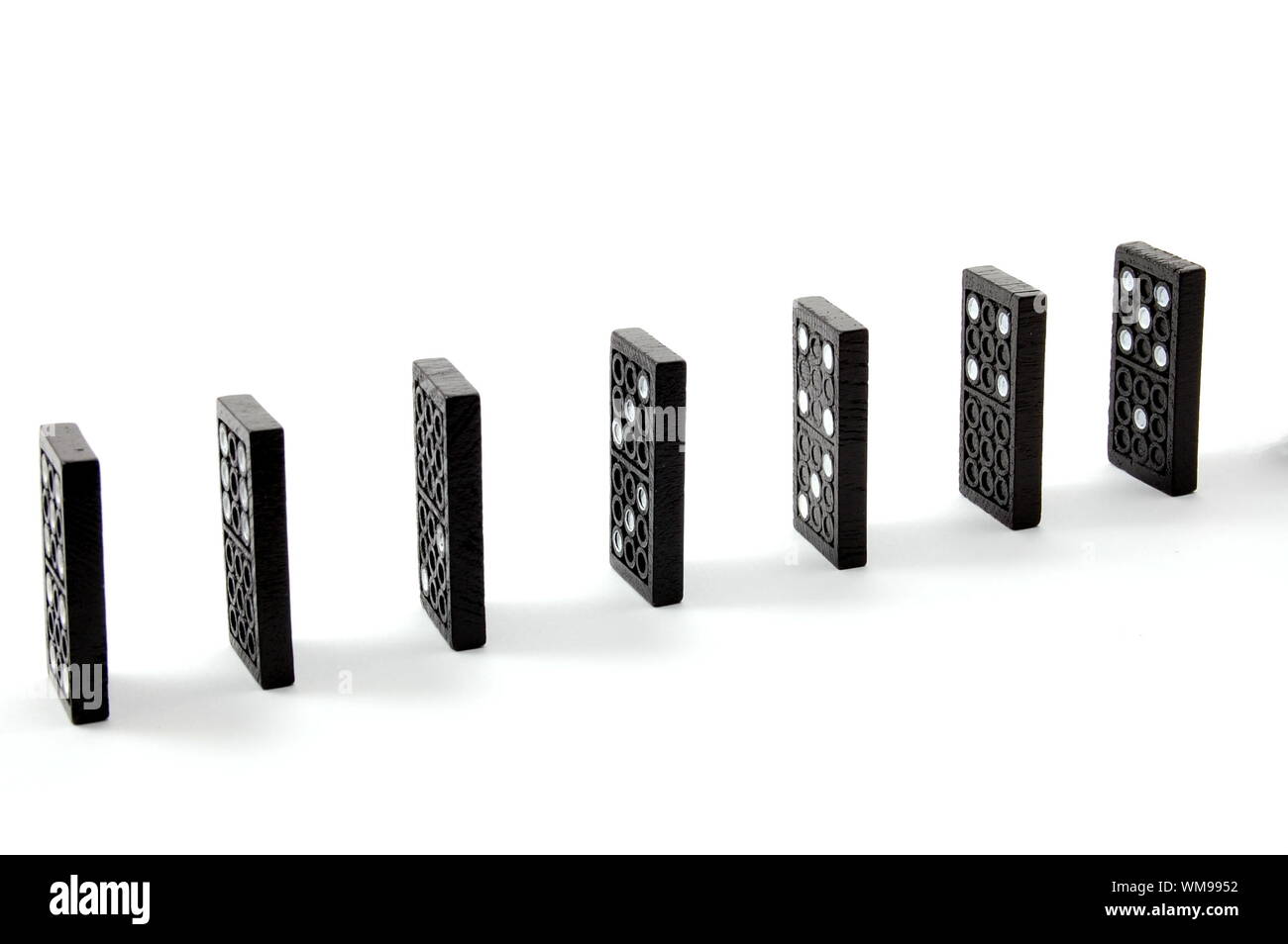 chain of dominoes isolated on a white background Stock Photo - Alamy