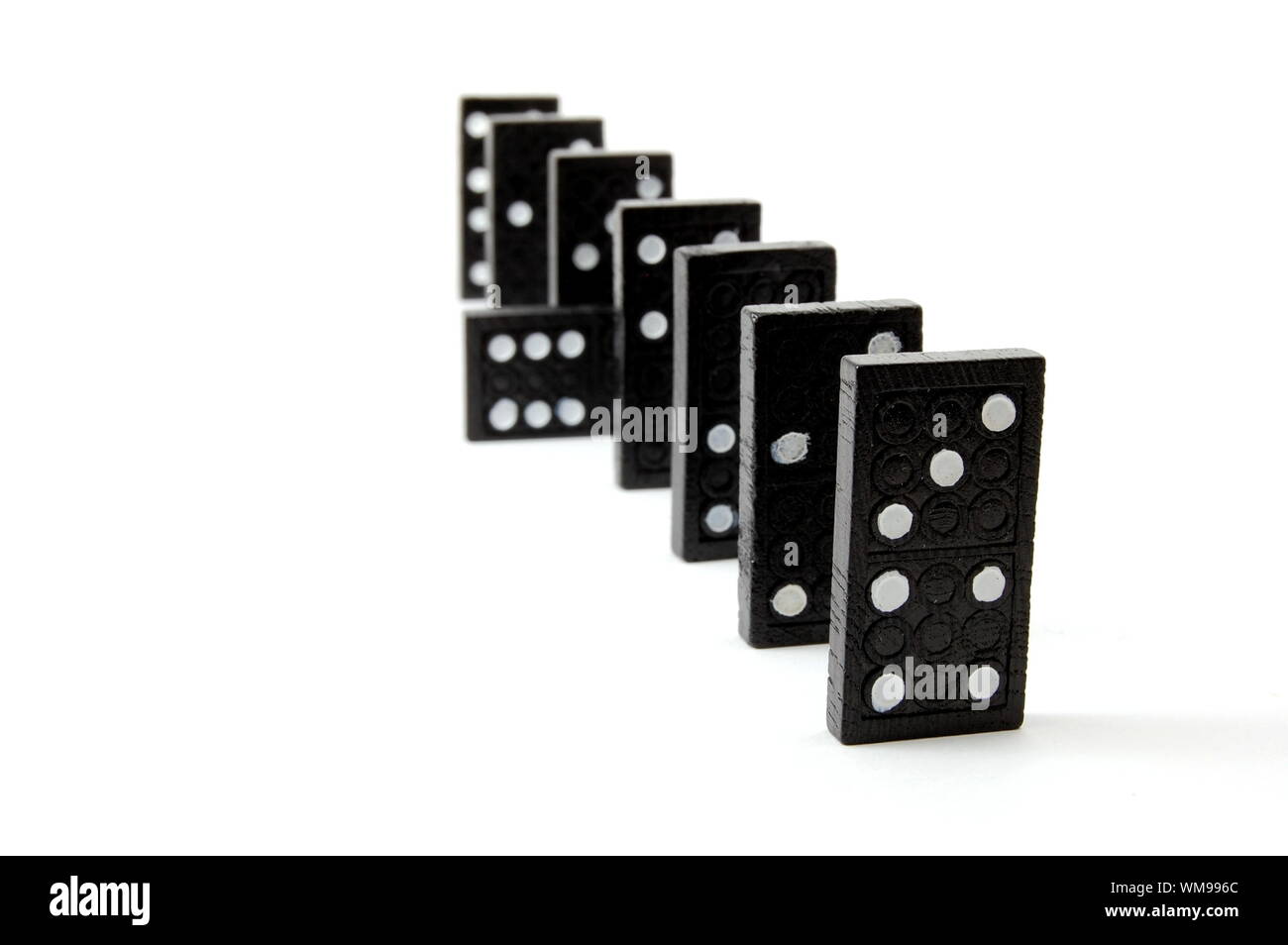 row of dominoes including a special domino stone isolated on white ...