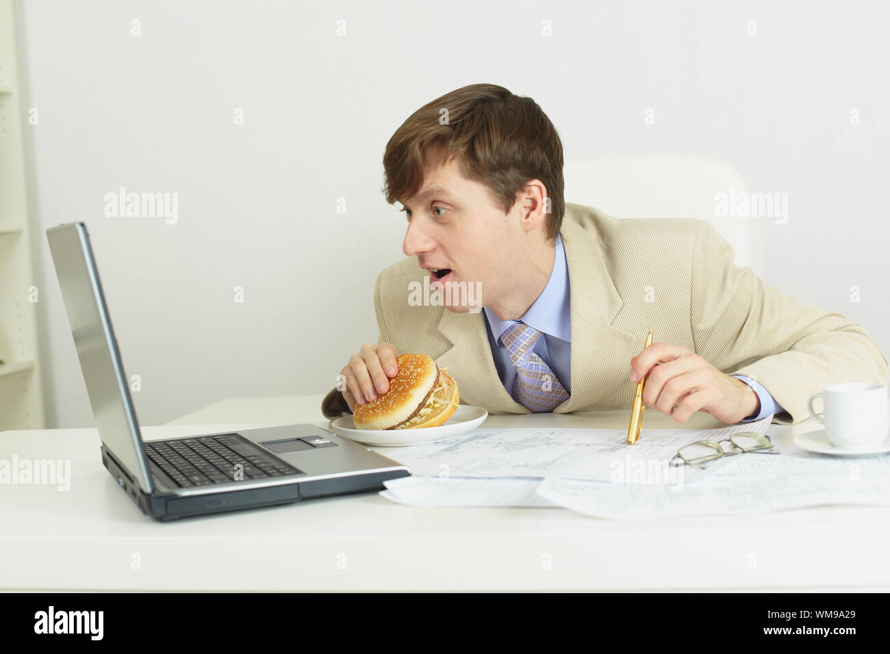 Hungry businessman manager eating sandwich hi-res stock photography and ...