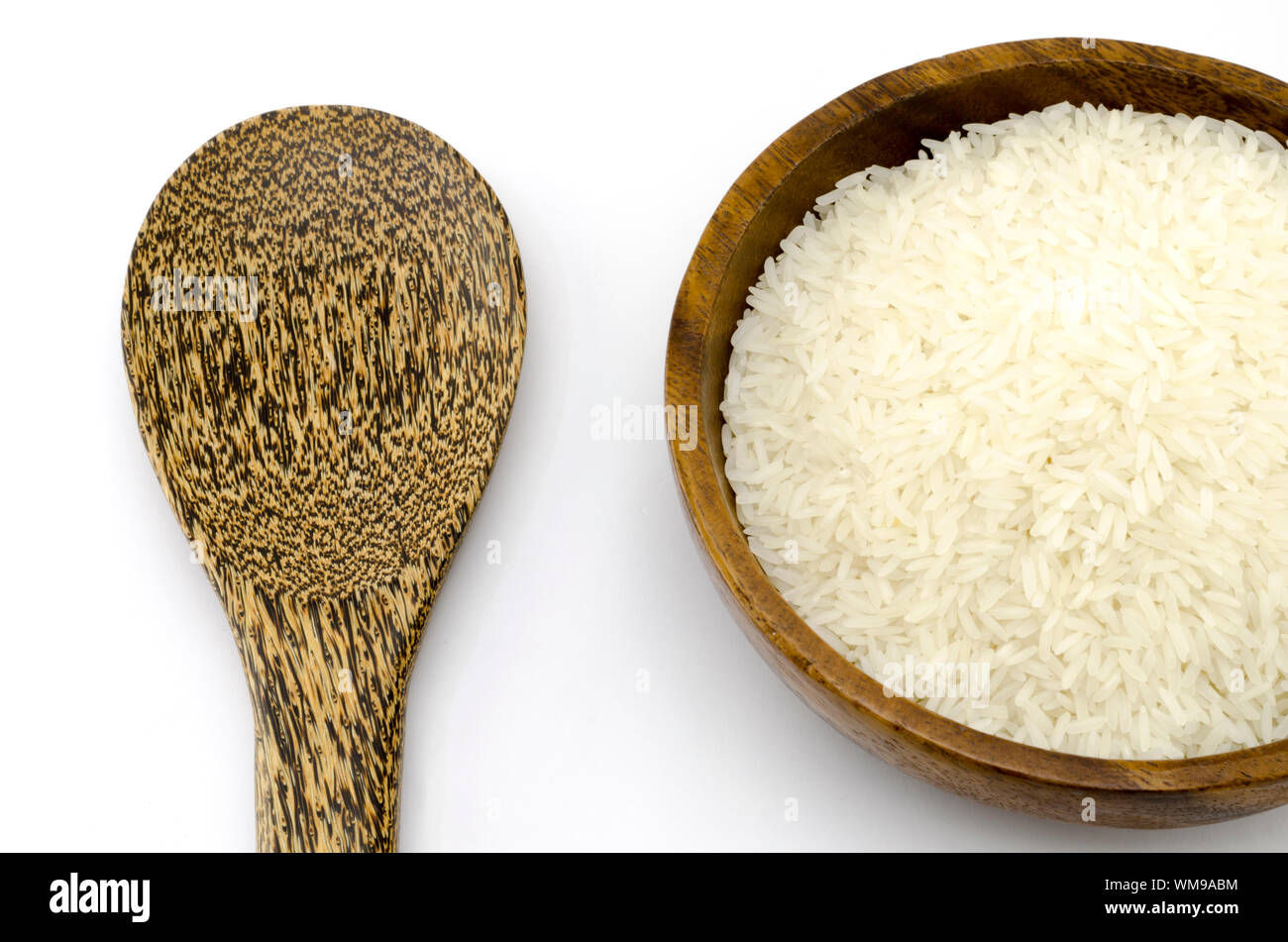 rice on wood bowl isolated on white background Stock Photo - Alamy