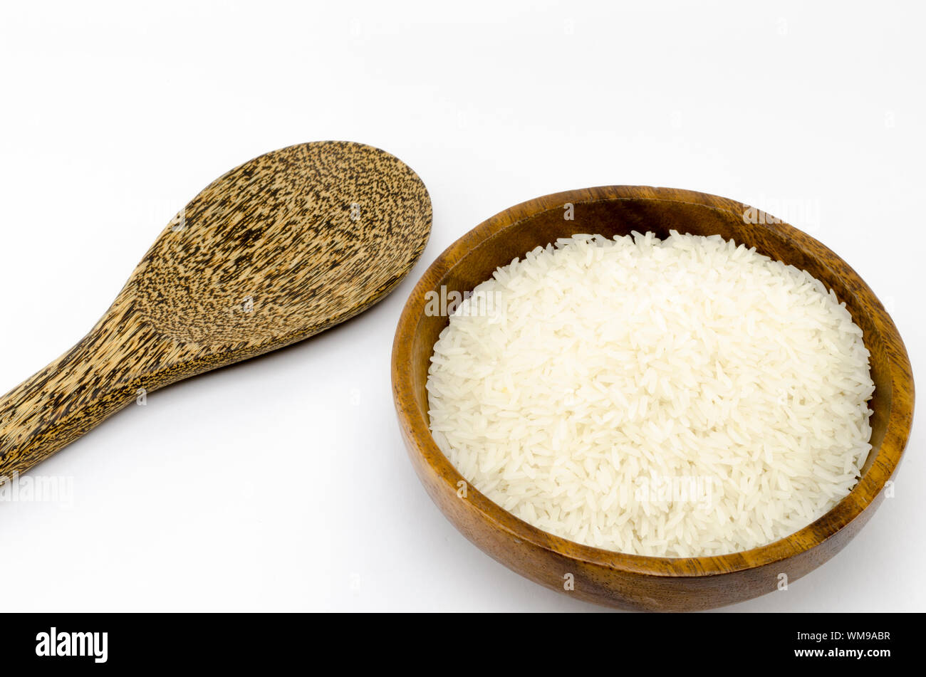 rice on wood bowl isolated on white background Stock Photo - Alamy