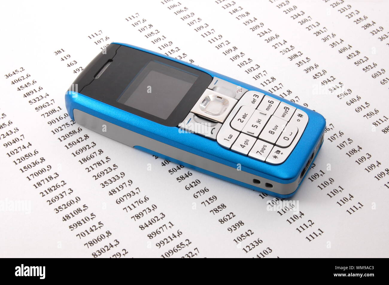 blue cell phone over business chart showing success Stock Photo - Alamy
