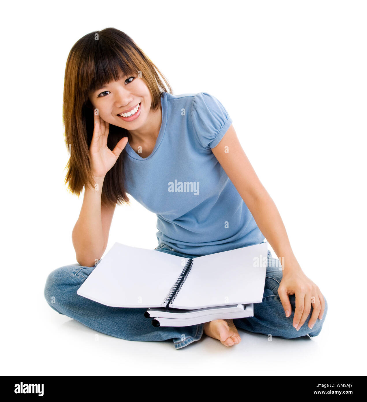 Asian student sitting on floor, blank book ready for text Stock Photo ...