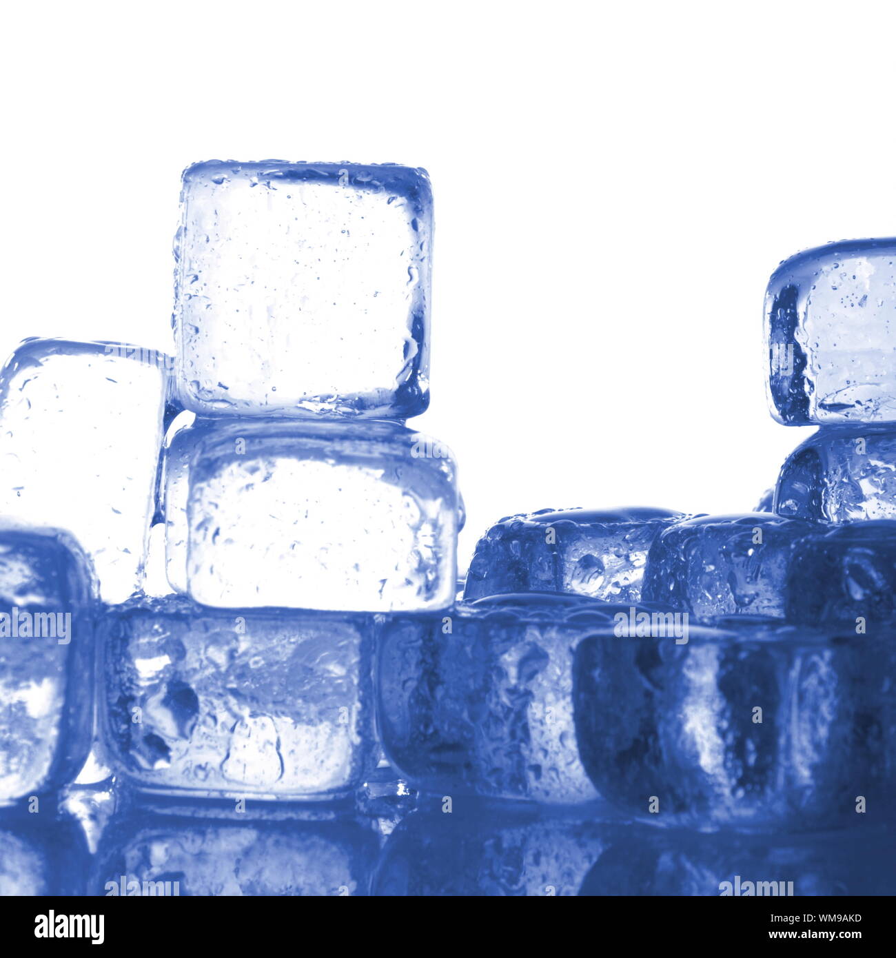 blue ice cubes with water drops melting Stock Photo - Alamy