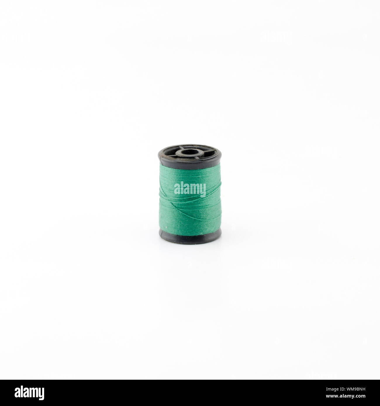 green sewing isolated on white background Stock Photo - Alamy