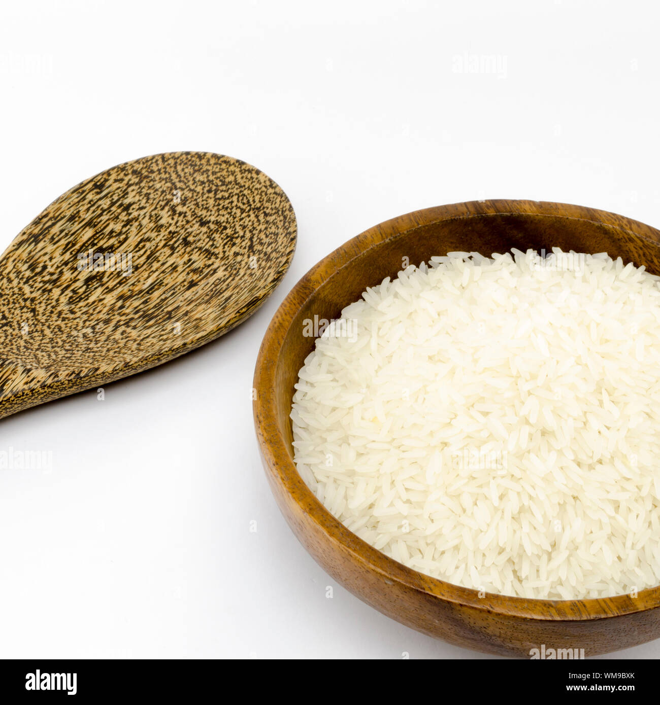 rice on wood bowl isolated on white background Stock Photo - Alamy