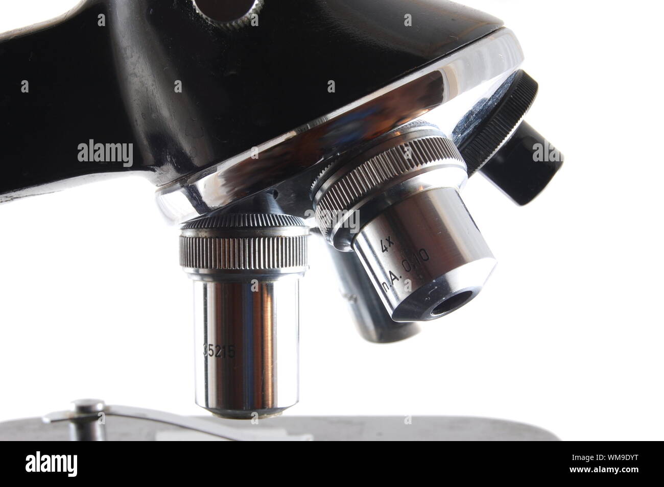 Old microscope isolated on a white background Stock Photo - Alamy