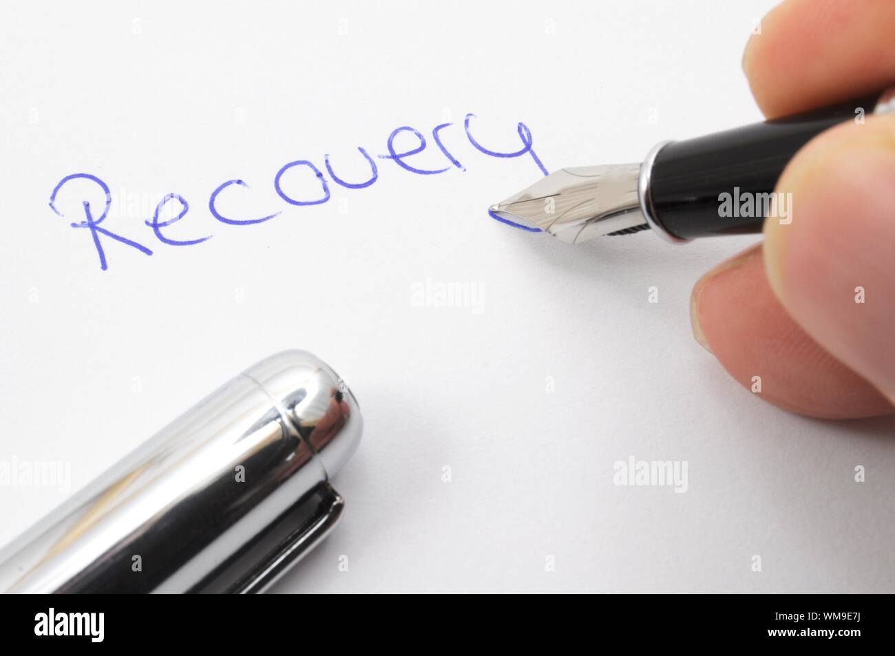 recovery concept with word written on paper and pen Stock Photo - Alamy