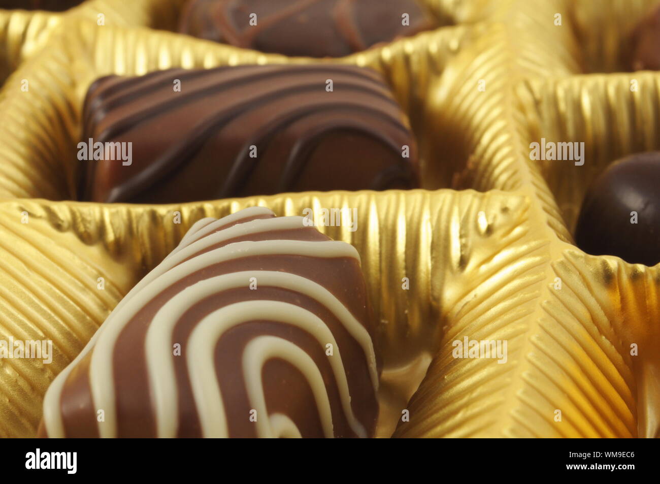 golden box of praline candy showing love concept Stock Photo - Alamy