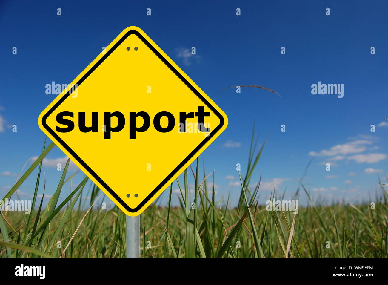 yellow road sign with support showing assistance concept Stock Photo ...