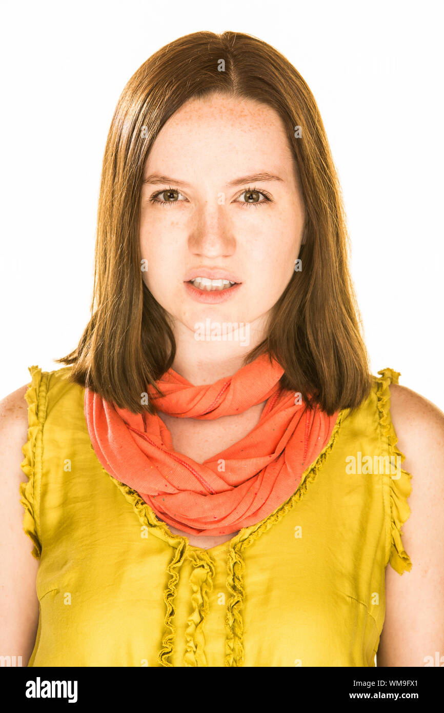 Pretty girl with an angry expression on white background Stock Photo ...