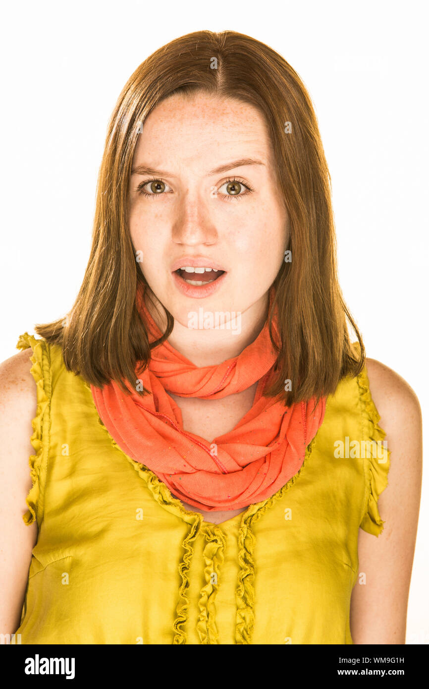 Pretty girl with a confused expression on white background Stock Photo ...