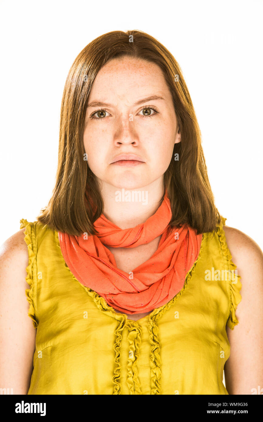 Pretty girl with an unhappy expression on white background Stock Photo ...