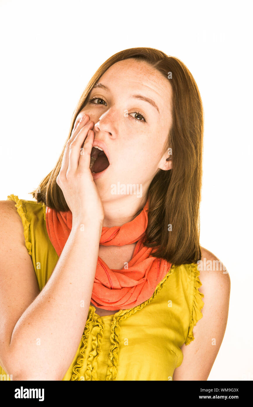 Pretty girl with a tired expression on white background Stock Photo - Alamy
