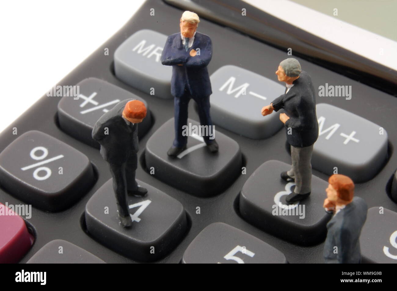 toy business man on calculator isolated on white background Stock Photo ...